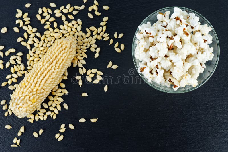 Heap of Raw and Cooked Popcorn Grains Isolated on Black Background ...
