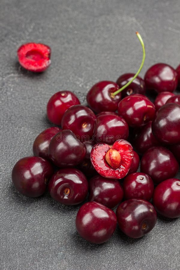 Cherries and a Half Cherry with Seed on a Dark Background Stock Photo ...