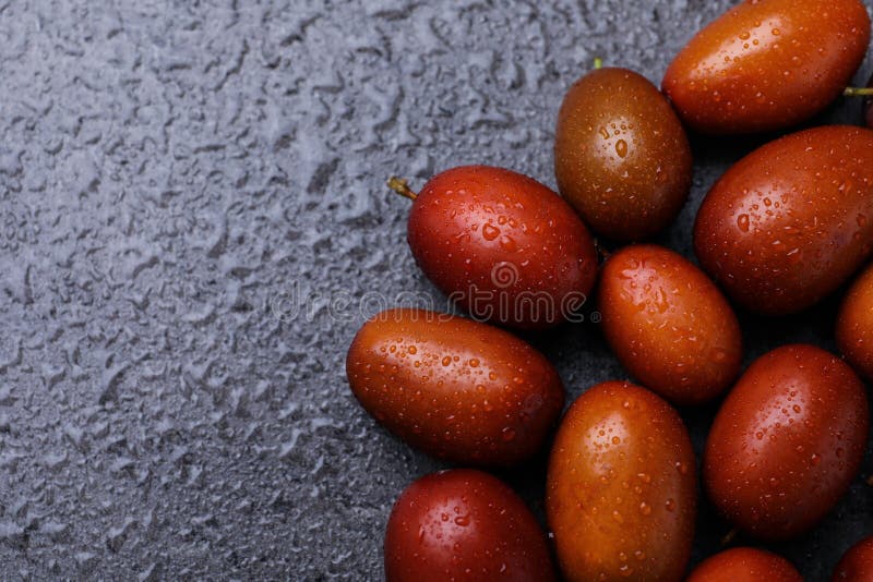 Heap of Ripe Red Dates with Water Drops on Grey Table, Top View. Space ...