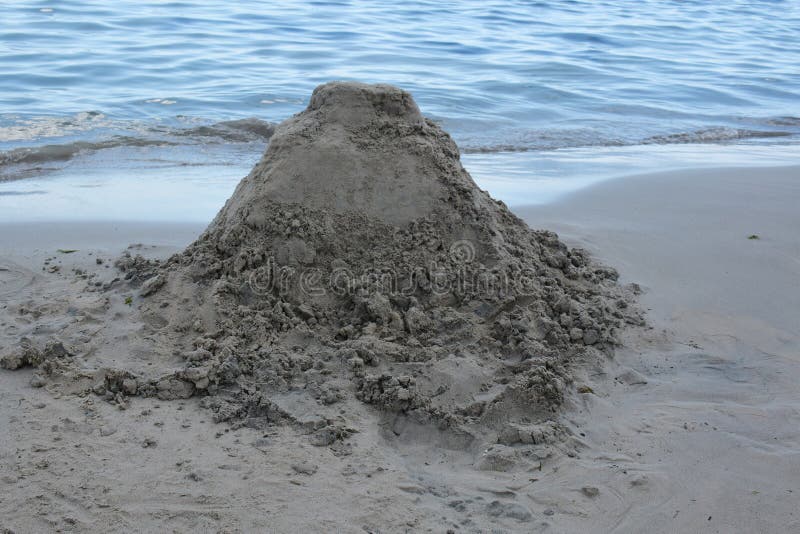 Heap of sand on the shore stock photo. Image of tranquil - 181540894