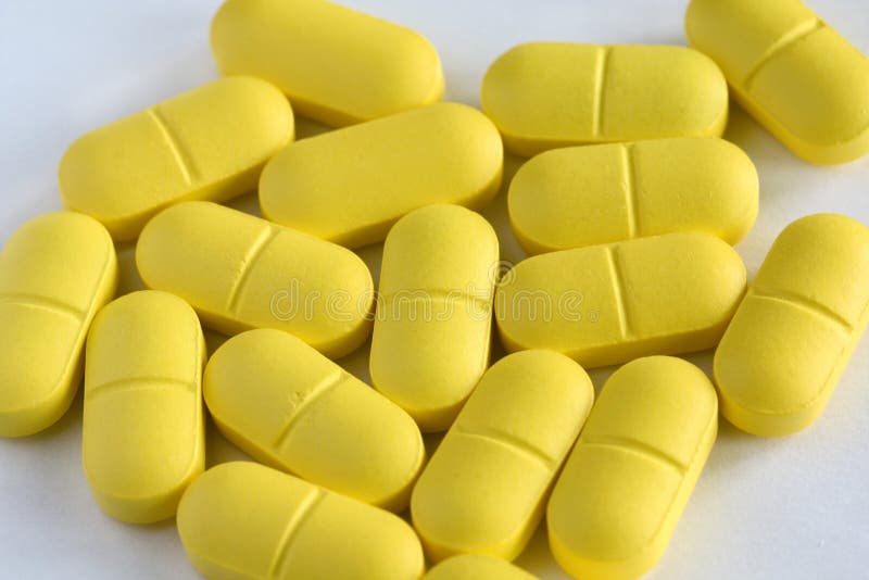Heap of yellow pills stock photo. Image of tablet, healthy - 18651410