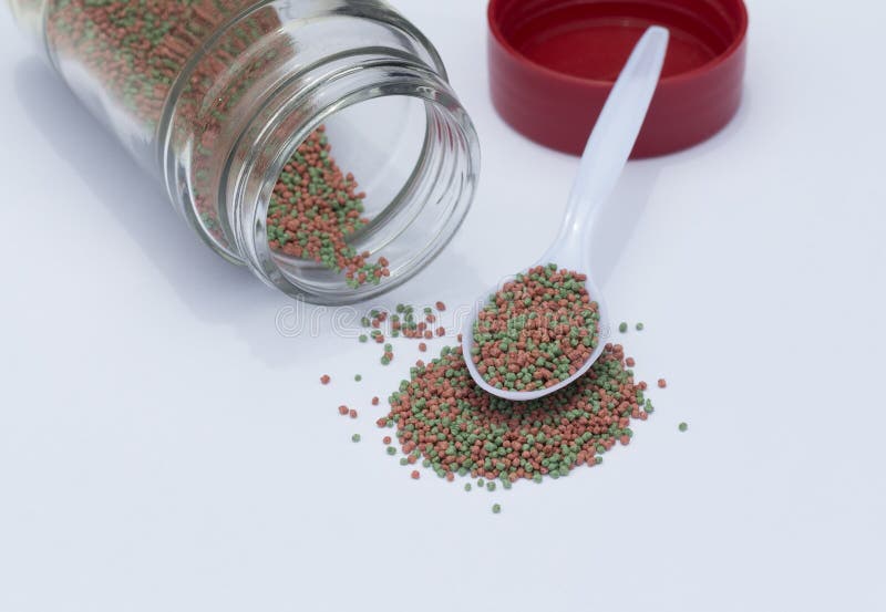 A Heaping Pile of Pet Fish Food on a White Background Stock Image ...