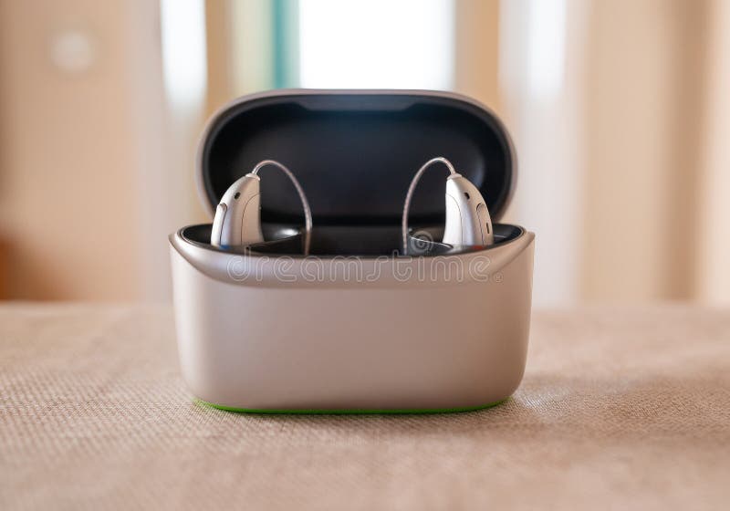 Hearing Aid Devices Charging in Portable Box on Table Surface Stock ...