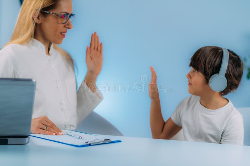 Hearing Test for Children. Audiologist Working with a Preschooler Boy ...