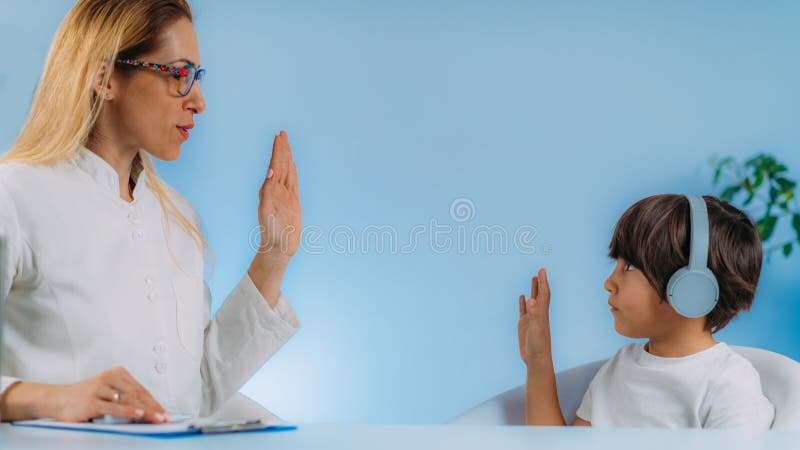 Hearing Test for Children. Audiologist Working with a Preschooler Boy ...