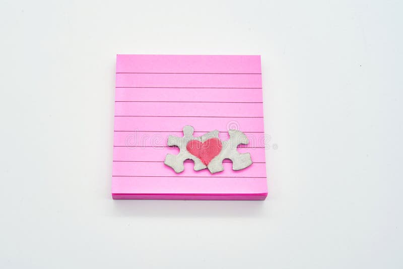 Heart on Connected Puzzle Pieces on Top of Post it Note Pad Stock Image ...