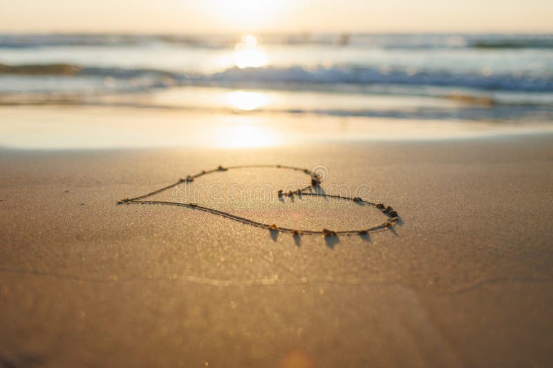 A Heart is Drawn on the Sand on the Beach at Sunset. Romantic Sunset on ...