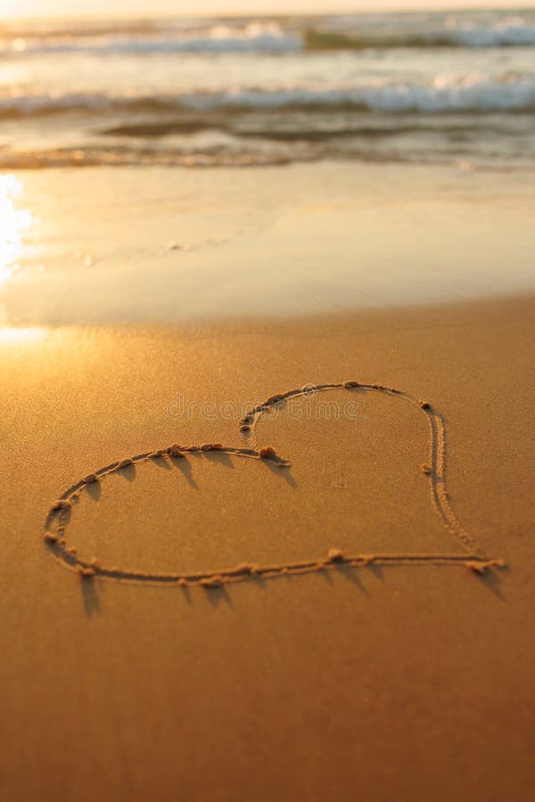 A Heart is Drawn on the Sand on the Beach at Sunset. Romantic Sunset on ...