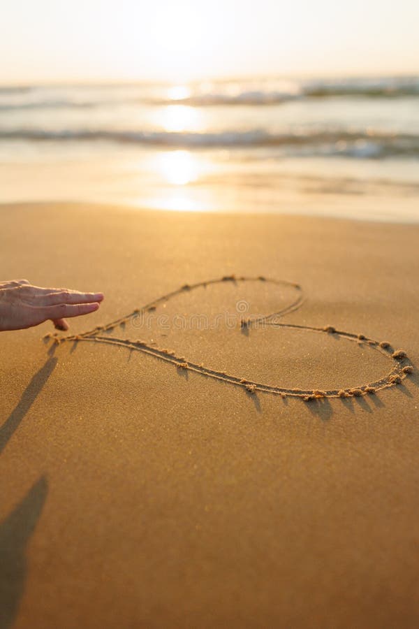 A Heart is Drawn on the Sand on the Beach at Sunset. Romantic Sunset on ...