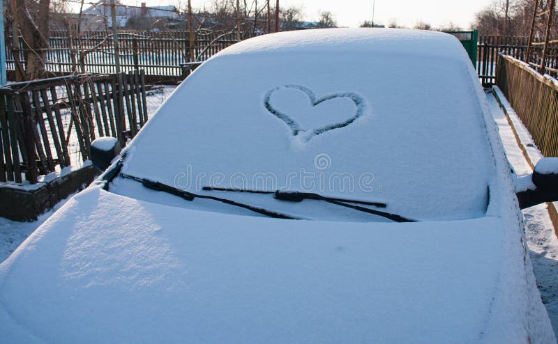 A Heart Drawn in the Snow on the Windshield of a Car. Stock Photo ...