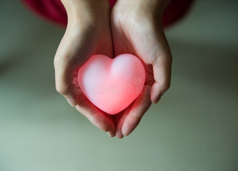Small Red Heart in Woman`s Hands in a Gesture of Giving, Protecting ...