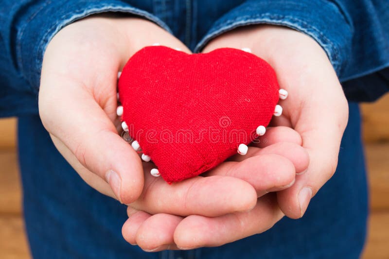 Heart in hands of a man stock photo. Image of holding - 108900312