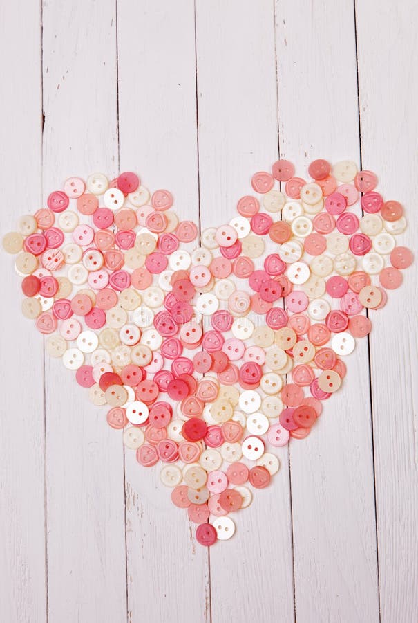 Heart Laid Out from the Buttons on a White Background Wooden Table ...