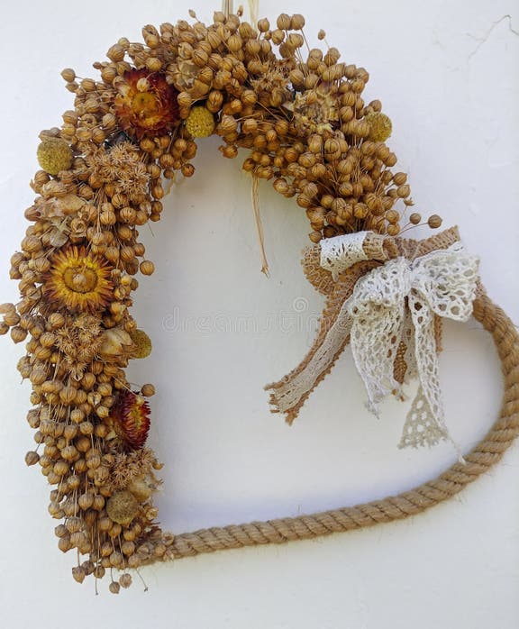 A Heart Made of Brown String and Dried Flowers Stock Image - Image of ...