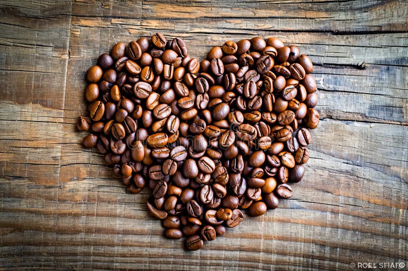 Heart Made Out of Coffee Beans Sits on Wooden Table. Generative AI ...