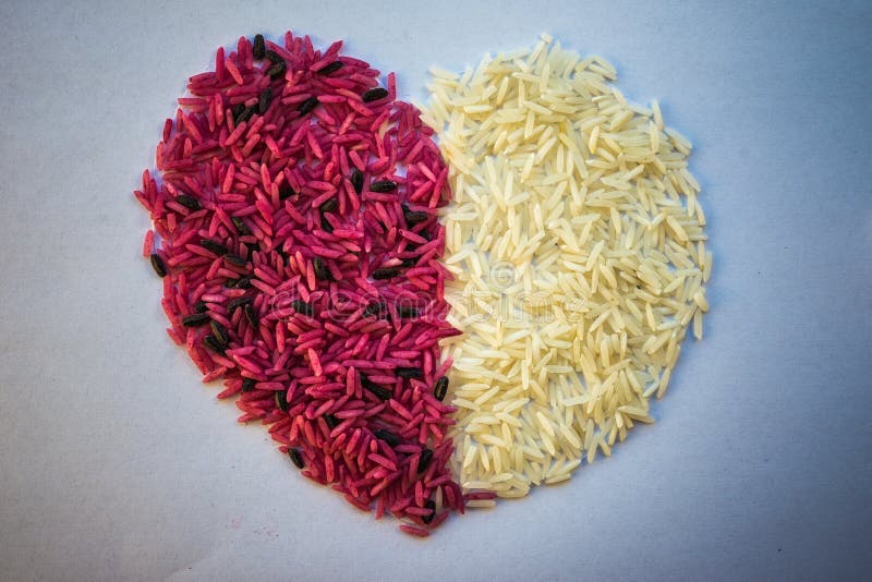 Heart Made with Pink and White Rice Grains on a Blue Surface Stock ...