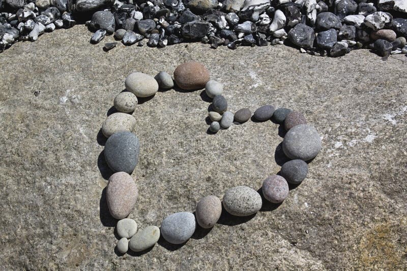 Heart of Pebble on a rock stock image. Image of happiness - 138679405