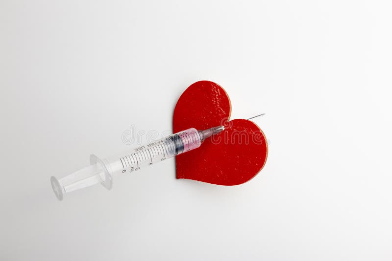 A Heart Pierced with a Medical Syringe with a Needle Stock Photo ...