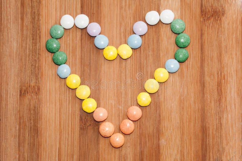 Heart of the Round Chocolate Candies on a Wooden Board Stock Photo ...