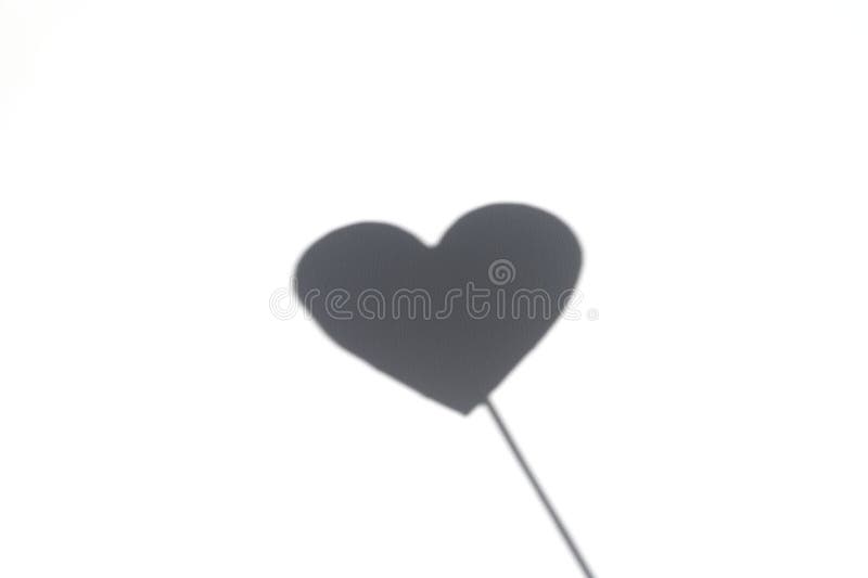 Heart Shadow on a Stick on a Textured White Background Stock Image ...