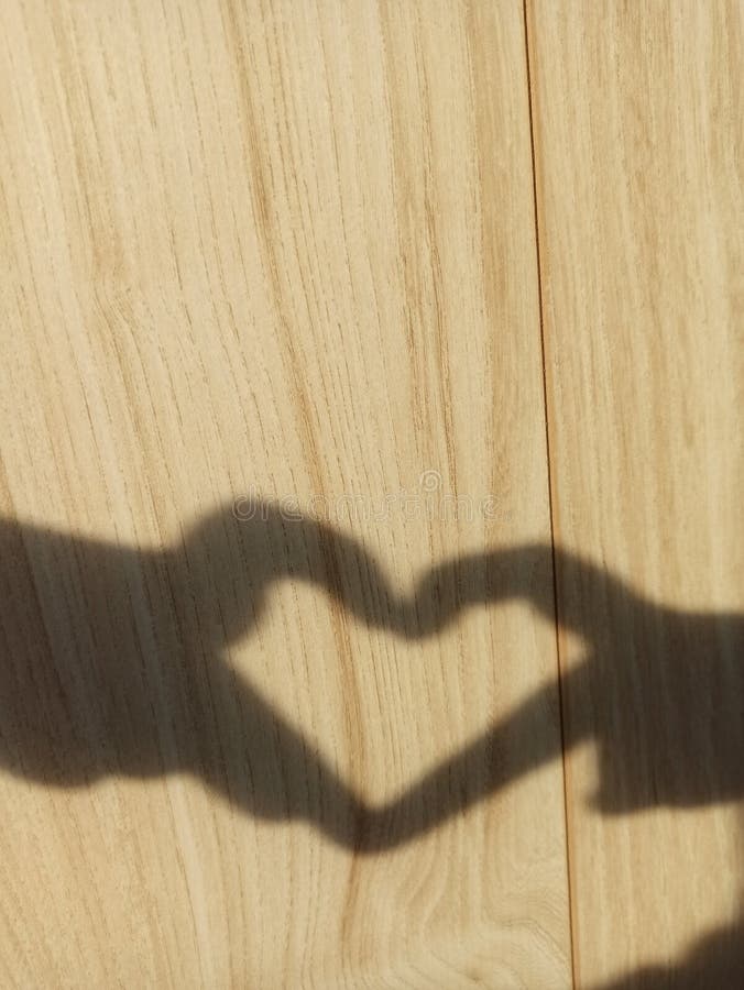 Heart shadow on the wall stock image. Image of wooden - 260642351