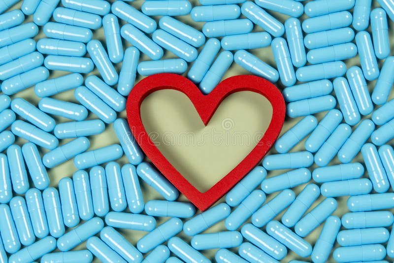 Heart Shape and Blue Capsules. Importance of Medication Treatment Stock ...