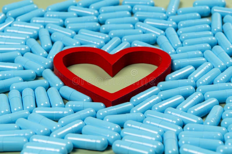 Heart Shape and Blue Capsules. Importance of Medication Treatment Stock ...