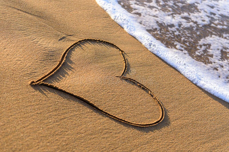 Heart Shape Drawn in the Sand on a Beach Stock Photo - Image of ...