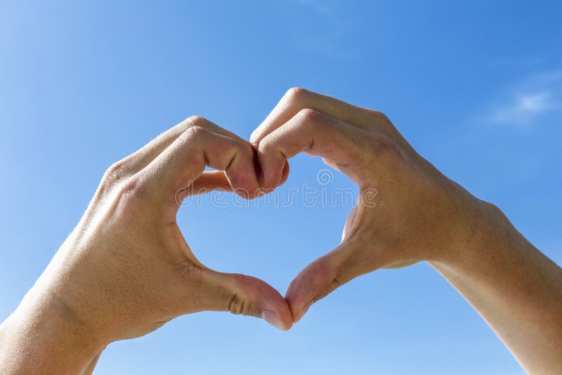 Heart Shape with Hand Under Blue Sky Stock Image - Image of clouds ...