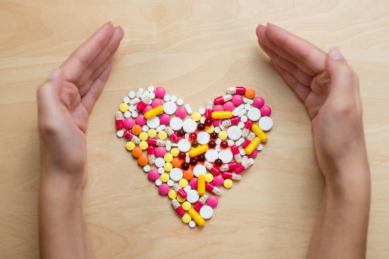 A Heart Shape Laid Out of Multi-colored Tablets on a Table, Covered ...
