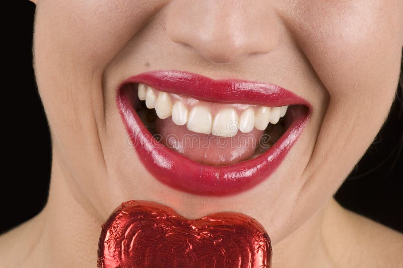 Heart Candy in Red Lips..Heart Candy in Red Lips. Stock Image - Image ...
