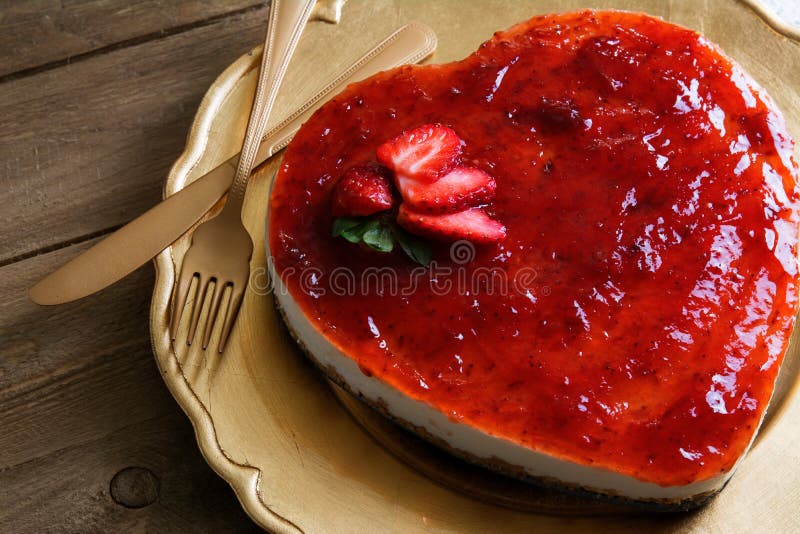 Heart Shaped Cheesecake with Raspberry Jelly on a Gold Plate Stock ...