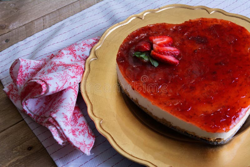 Heart Shaped Cheesecake with Raspberry Jelly on a Gold Plate Stock ...