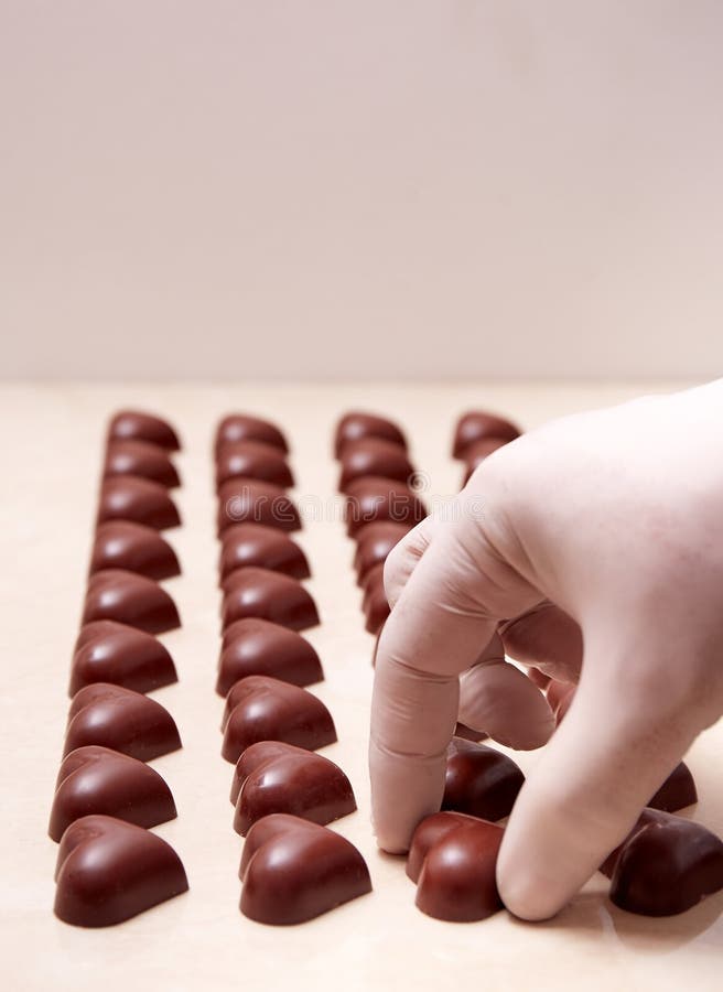 Heart-shaped Chocolates Being Ordered by a Gloved Hand Stock Image ...