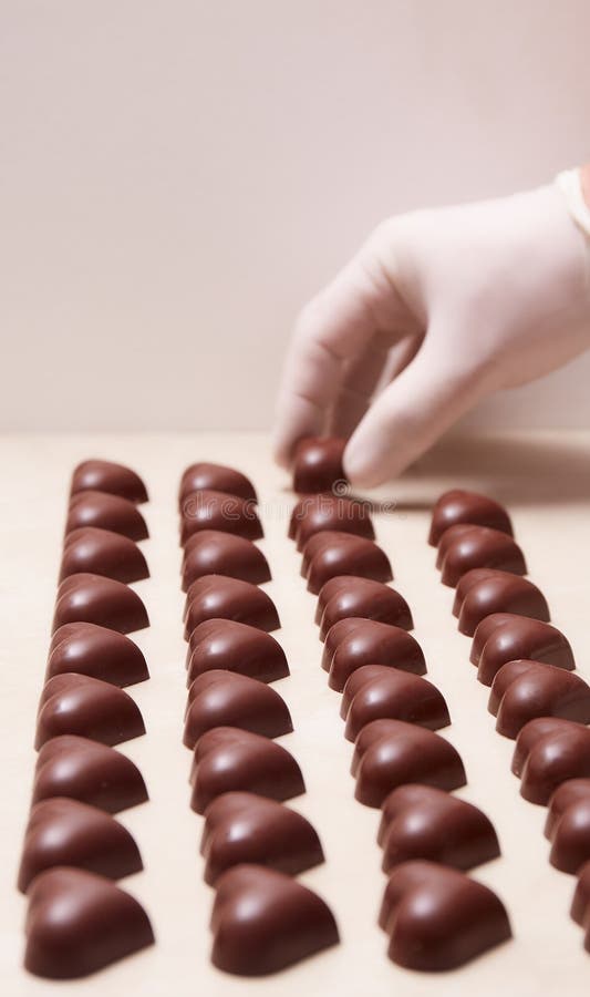Heart-shaped Chocolates Being Ordered by a Gloved Hand Stock Image ...