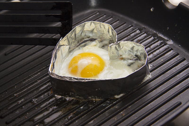 Heart shaped fried eggs stock photo. Image of cook, plate - 56779492