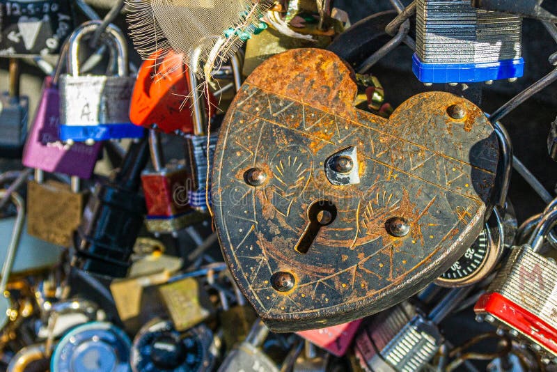 Rusty Heart Shaped Lock on a Fence with Many Other Locks, Close-up ...