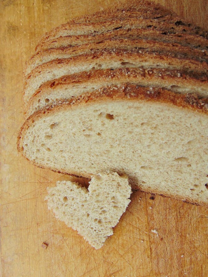 Heart Shaped Piece of Bread in Front of Full Bread Stock Image - Image ...
