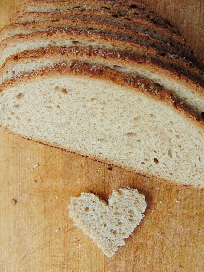 Heart Shaped Piece of Bread in Front of Full Bread Stock Photo - Image ...
