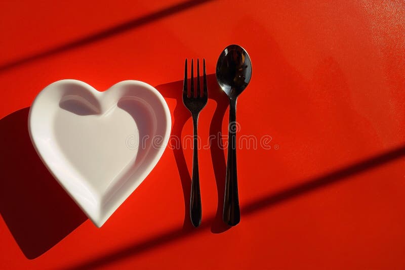 A Heart Shaped Plate Sits Next To Fork on a Red Table Setting. Romantic ...