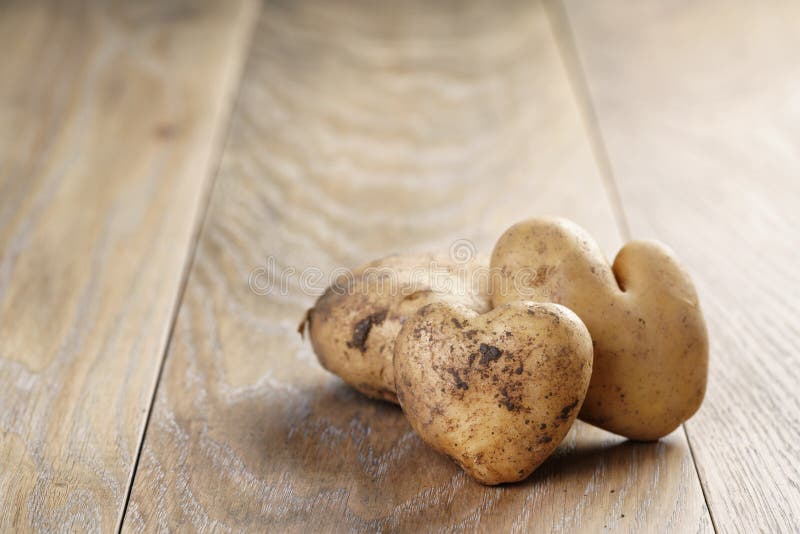 Heart Shaped Potatoes on Oak Table Stock Image - Image of food, herbs ...