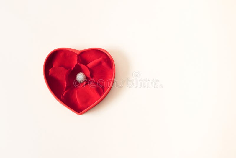 A Heart Shaped Red Box Filled with Petals and Pearl. Flat Lay Stock ...