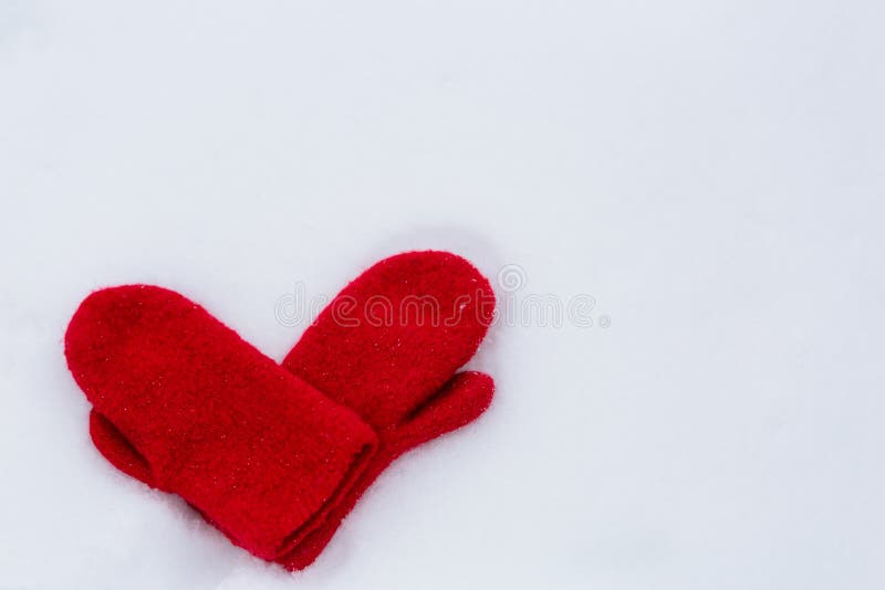 Female Hands in White Knitted Mittens with a Glossy Red Heart on a Snow ...