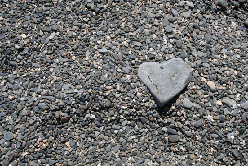 Heart shaped rock on beach stock photo. Image of pebbles - 25791890
