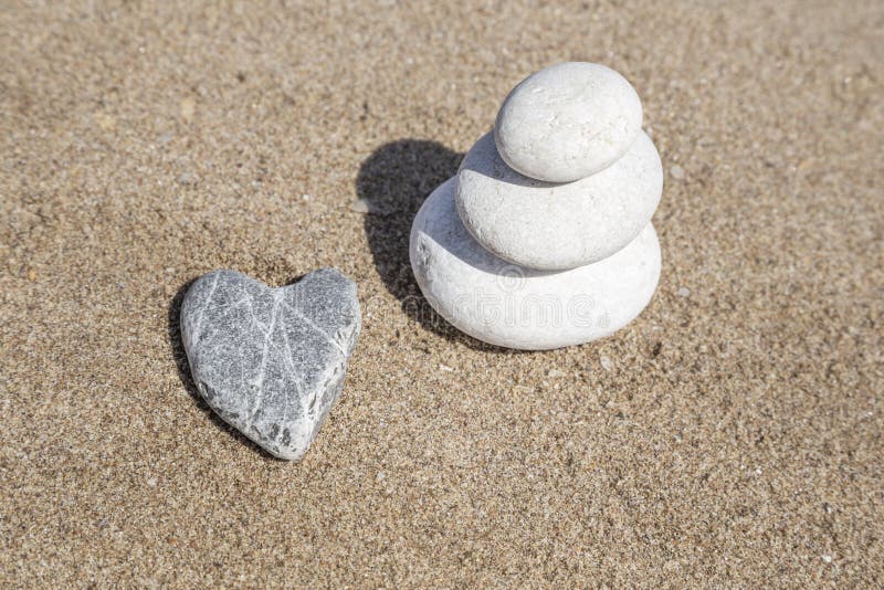 Heart Shaped Stone and Pebbles on Balance on Sand Stock Photo - Image ...
