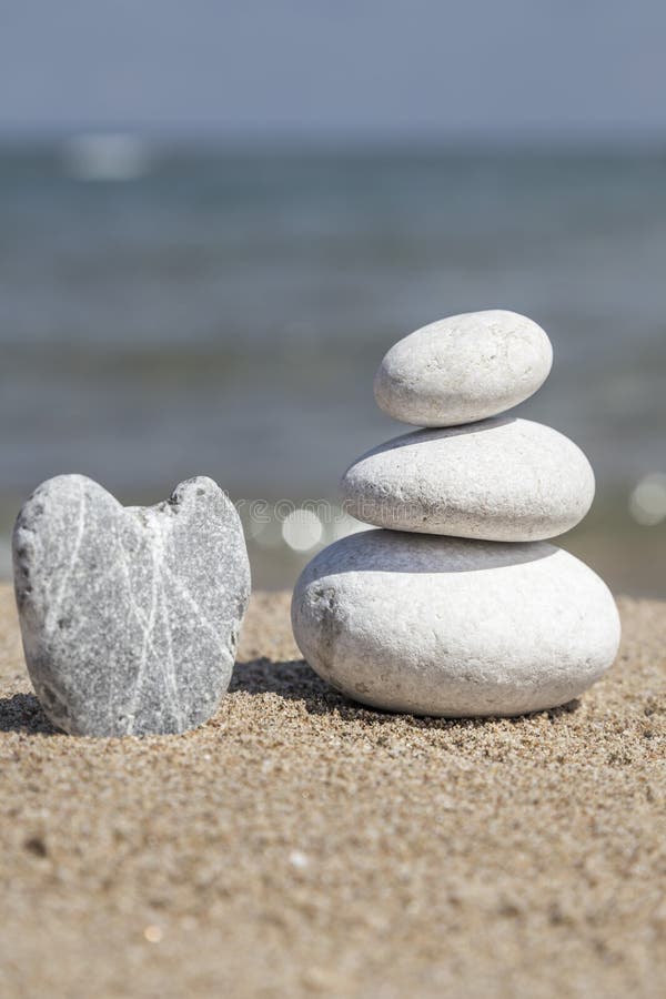 Heart Shaped Stone and Stack of Pebbles on Balance on Sand Stock Photo ...