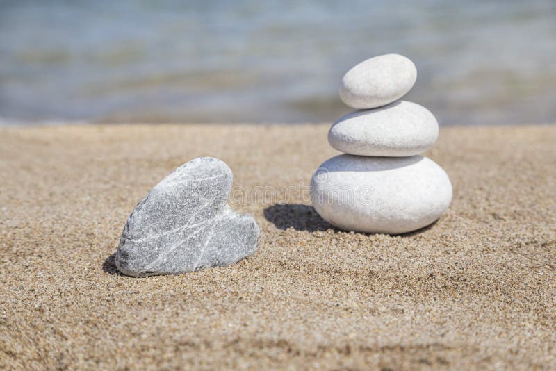 Heart Shaped Stone and Stack of Pebbles on Balance on Sandy Beach Stock ...