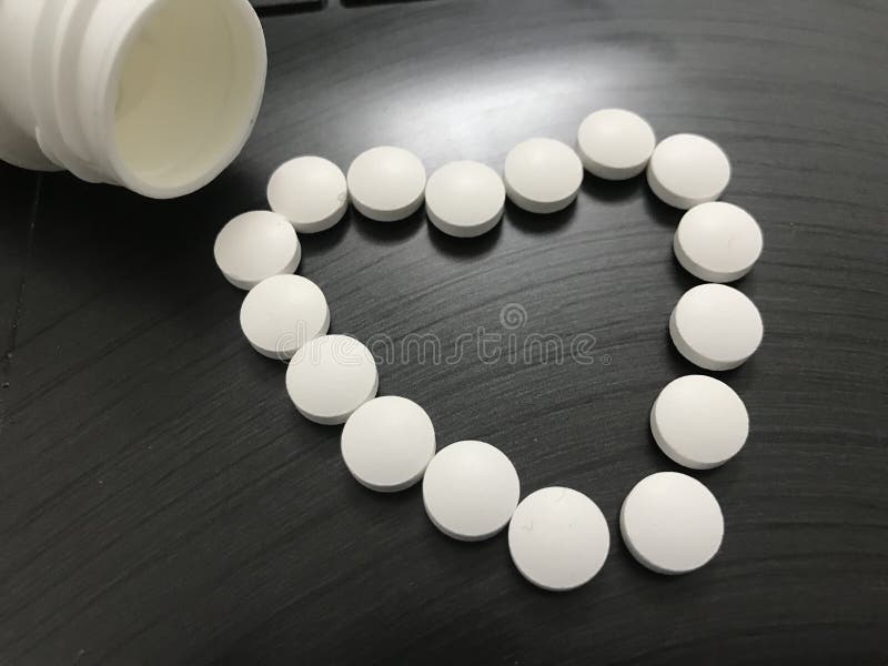 Heart Shaped Tablets Laid on Laptop Computer Background by an Software ...