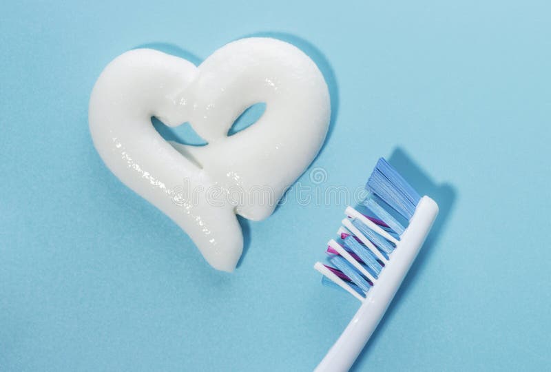 Heart Shaped Toothpaste and Toothbrush on Blue Background, Top View ...