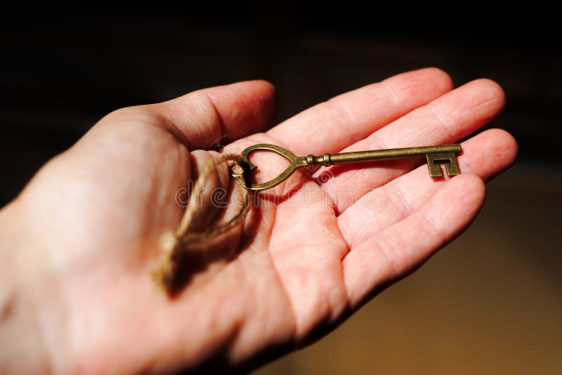 Heart Shaped Vintage Skeleton Key in Hand on Dark Background Stock ...